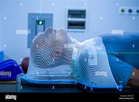 Patient In Mask For Whole Brain Radiotherapy Treatment Or Total Brain Radiotherapy To Target