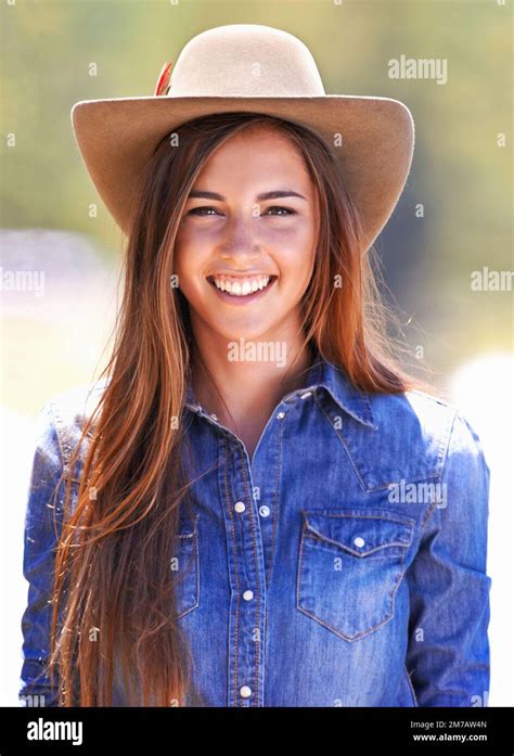 Owning The Cowgirl Look An Attractive Young Cowgirl Standing In The