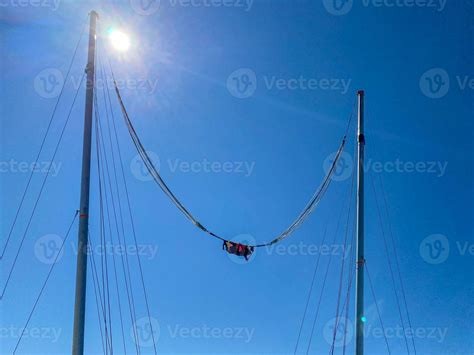 Launching A Catapult In An Amusement Park With Two People Sitting In A