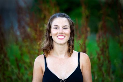 Beautiful Young Brunette Woman Standing Outdoors And Smiles Stock Image