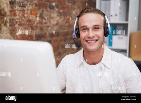 Man With Headset Typing On Laptop Stock Photo Alamy