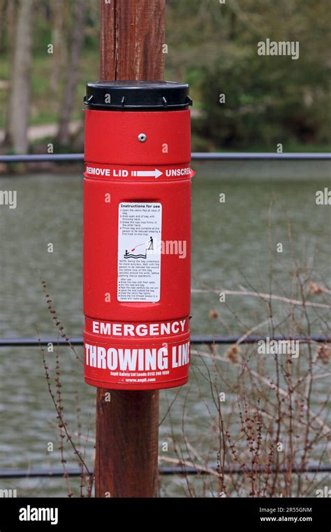 Red Box Containing Emergency Throwing Line At Side Of Large Pond Stock
