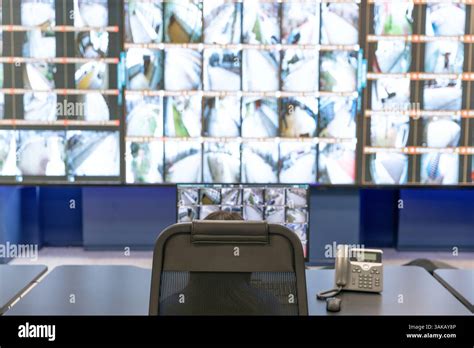Security Officer Monitoring Multiple Surveillance Screens In A High