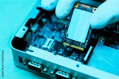 Hand Holding Tiny Electronic Circuit Board Inserting To The Socket