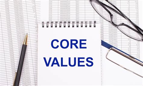 Premium Photo A White Notepad With The Text Core Values A Pen Reports And Glasses Lie On A