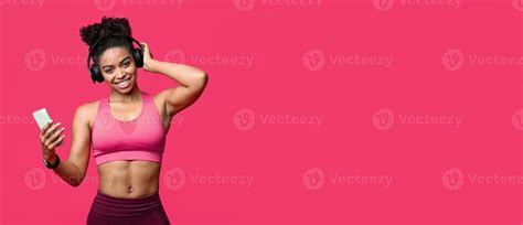 Joyful Sporty Afro Woman Listening To Music While Training Holding Smartphone Wearing Wireless