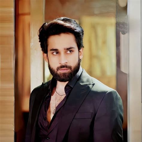 A Man With A Beard Wearing A Suit