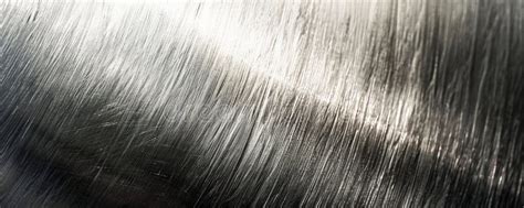Metallic Background With A Brushed Nickel Finish Reflecting Soft Light And Featuring Subtle