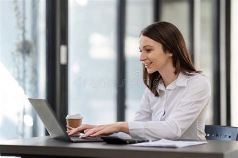 Professional Business Woman Working On A Desk With Laptop In Modern