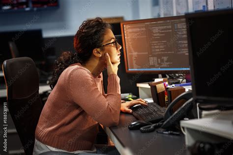 Late At Night A Dedicated Female Programmer Works Diligently Driven By Determination And