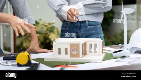 Sustainability And Architectural Model Professionals Discussing A