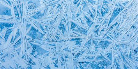 Crystalline Patterns Dance Across The Cool Expanse Of The Blue Ice