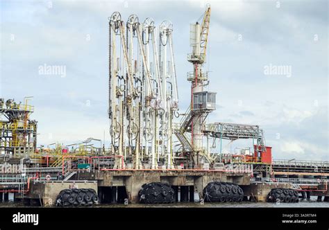 View Of An Industrial Oil Terminal With Large Loading Arms And Marine