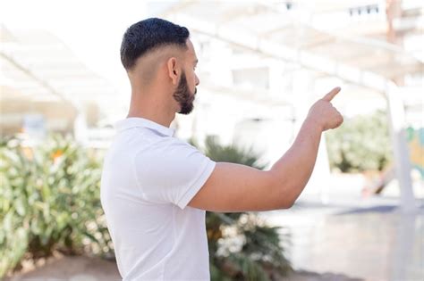 Premium Photo Standing And Pointing To Object On Copy Space Rear View