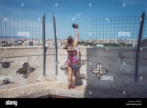 A Woman Takes A Photograph Of The City From The Top Of The El Miguelete