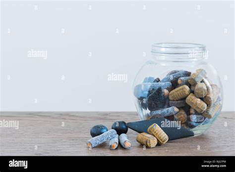 Different Kinds Of Salmiakki Candy In Small Jar And On Table Stock