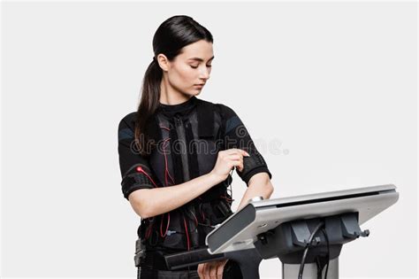Fit Girl Is Connecting Contactor To EMS Suit That Uses Electrical Impulses To Stimulate Muscles