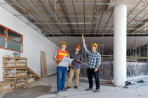 Construction Concept Of Engineer And Architect Working With Construction Model And Blueprint At