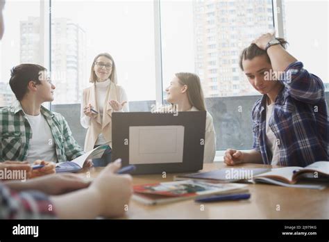 Happy College Students Enjoying Learning From Their Experienced Female