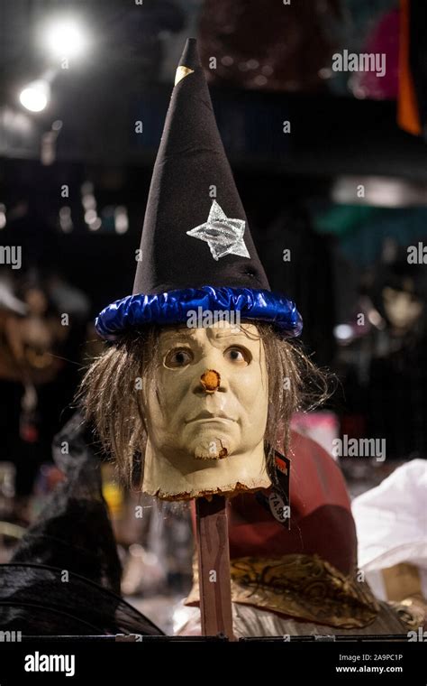 A Costume Store Still Life Of A Rubber Mask Wearing A Dunce Cap And A
