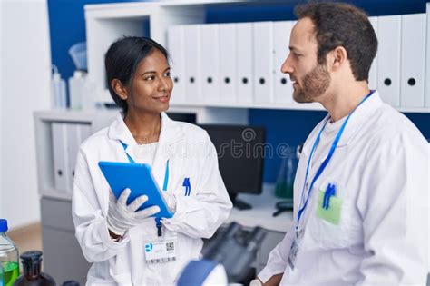 Man And Woman Scientists Using Touchpad Working At Laboratory Stock Image Image Of American