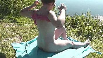 Solo Beautiful Cute Girl Assol Sunbathes On River Bank On Wild Beach In Dress Without Panties