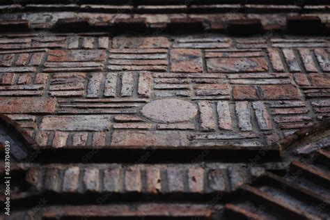 a brick wall has complex brickwork going vertically horizontally and