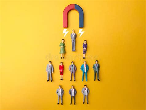 Array Of Figurines Arranged In A Pattern With A Magnet And An Arrow