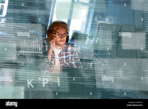 Young Concentrated Computer Developer Writing New Code In Glasses Stock