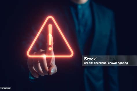 Hand Showing Red Triangle Caution Warning Sign For Maintenance Notification Error And Risk
