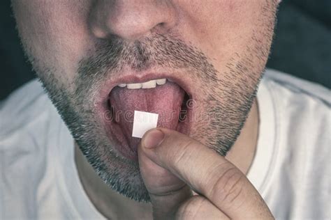 Man With Lsd On The Tongue On A Black Background White Stamp With