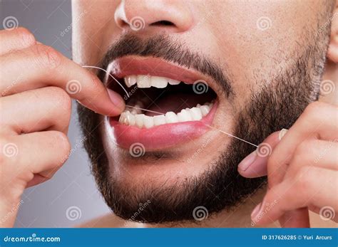 Man Cleaning And Teeth With Floss In Studio For Oral Hygiene Mouth