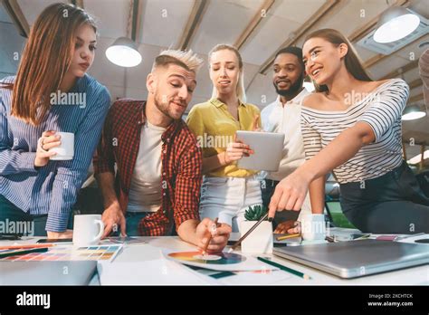 Creative Team Collaborates On Design Project In Modern Office During