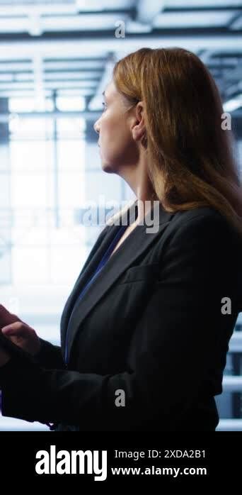 Vertical Video System Administrator Doing Yearly Maintenance Using Tablet To Prolong Data Center