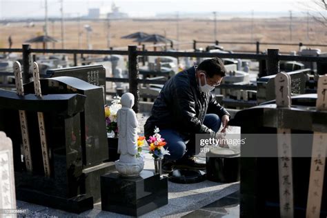 A Man Prays For His Wife Who Was Killed By The 2011 Great East Japan