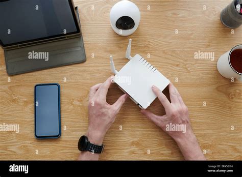 Hands Of Man Connecting Surveillance Camera To Wi Fi Router View From Above Stock Photo Alamy