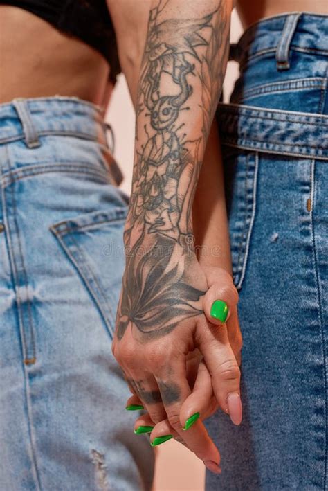 Closeup Of Two Young Lesbian Women In Denim Jeans Holding Each Other