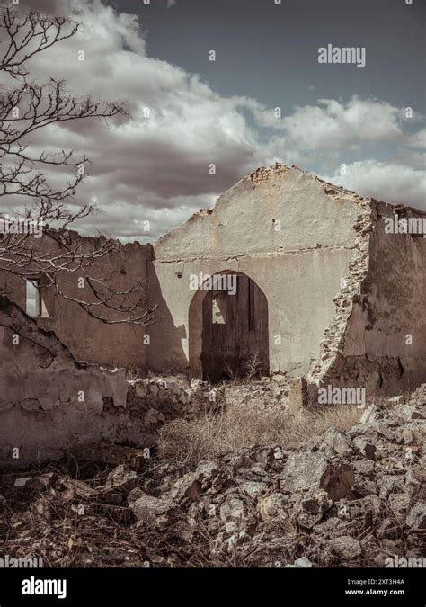 A Haunting Image Of A Derelict Building With Broken Walls And A Cloudy