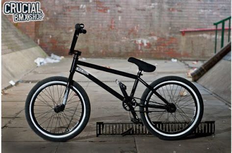 Black And White Bmx Bicycle Parked Next To Brick Wall