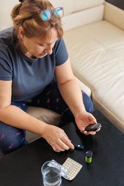 Premium Photo Woman Measures Blood Sugar Glucose Meter Diabetes Concept Notebook For Writing