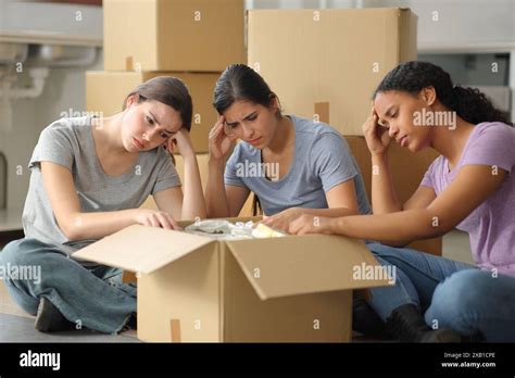 Three Sad Roommates Complaining Boxing Belongings Moving House Stock Photo Alamy