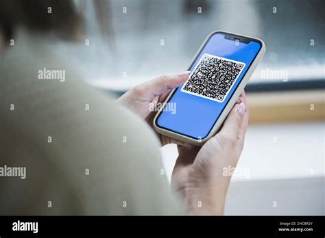 Woman Holding Mobile Phone With QR Code On Screen Stock Photo Alamy