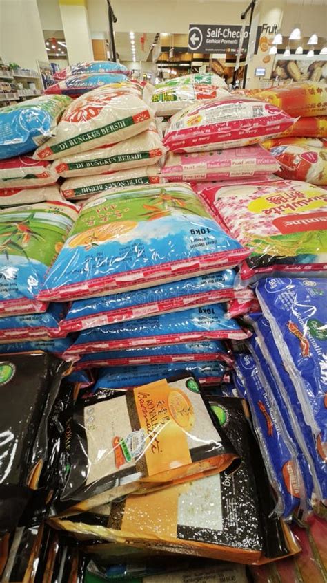 Stack Of Various Brands Of Rice Bags On Display And Sale Editorial