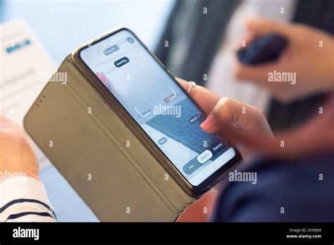 Conference Staff Member Scan A QR Code From Attendee Upon Arrival To Check In Site Stock Photo