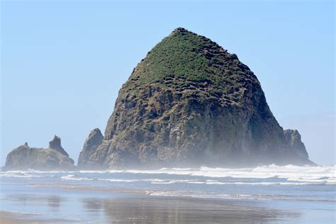 Giant Rock Coming Out Of The Sea At Cannon Beach Oregon Image Free