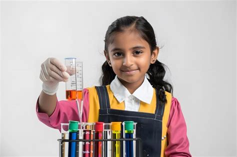 A Girl Is Holding A Test Tube With A Red And Blue Marker Premium Ai