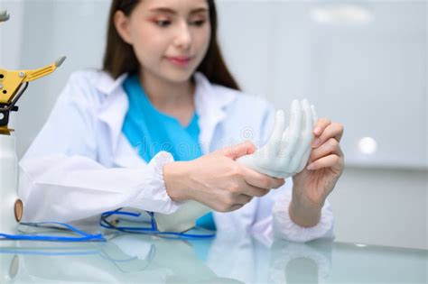 technician testing robotic bionic arm at prosthetic manufacturing stock