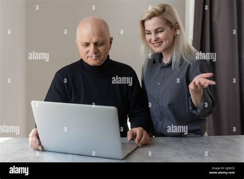 Front View Happy Elderly 70s Grey Haired Man Learning Using Computer Software With Caring Grown