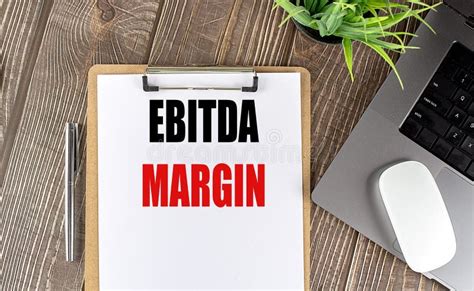 Ebitda Margin Text On Clipboard Paper With Laptop Mouse And Pen Stock Image Image Of