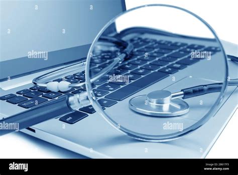 Tools For Diagnostics On The Laptop Through A Magnifying Glass Stock Photo Alamy